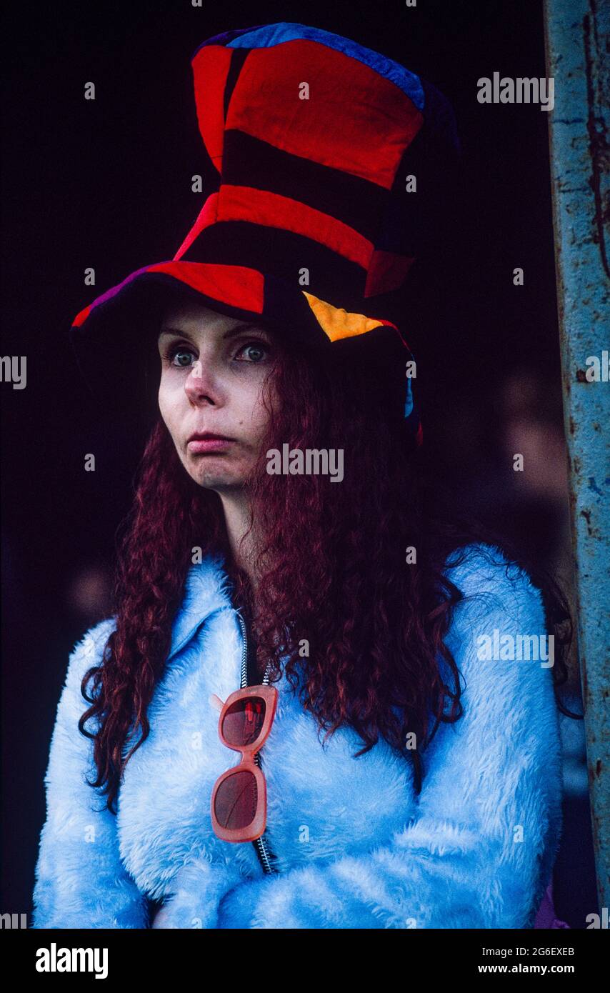 A woman standing outside in the early morning after attending, Tribal ...