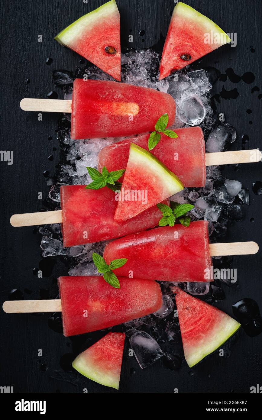 Watermelon ice cream on black wooden table Stock Photo - Alamy