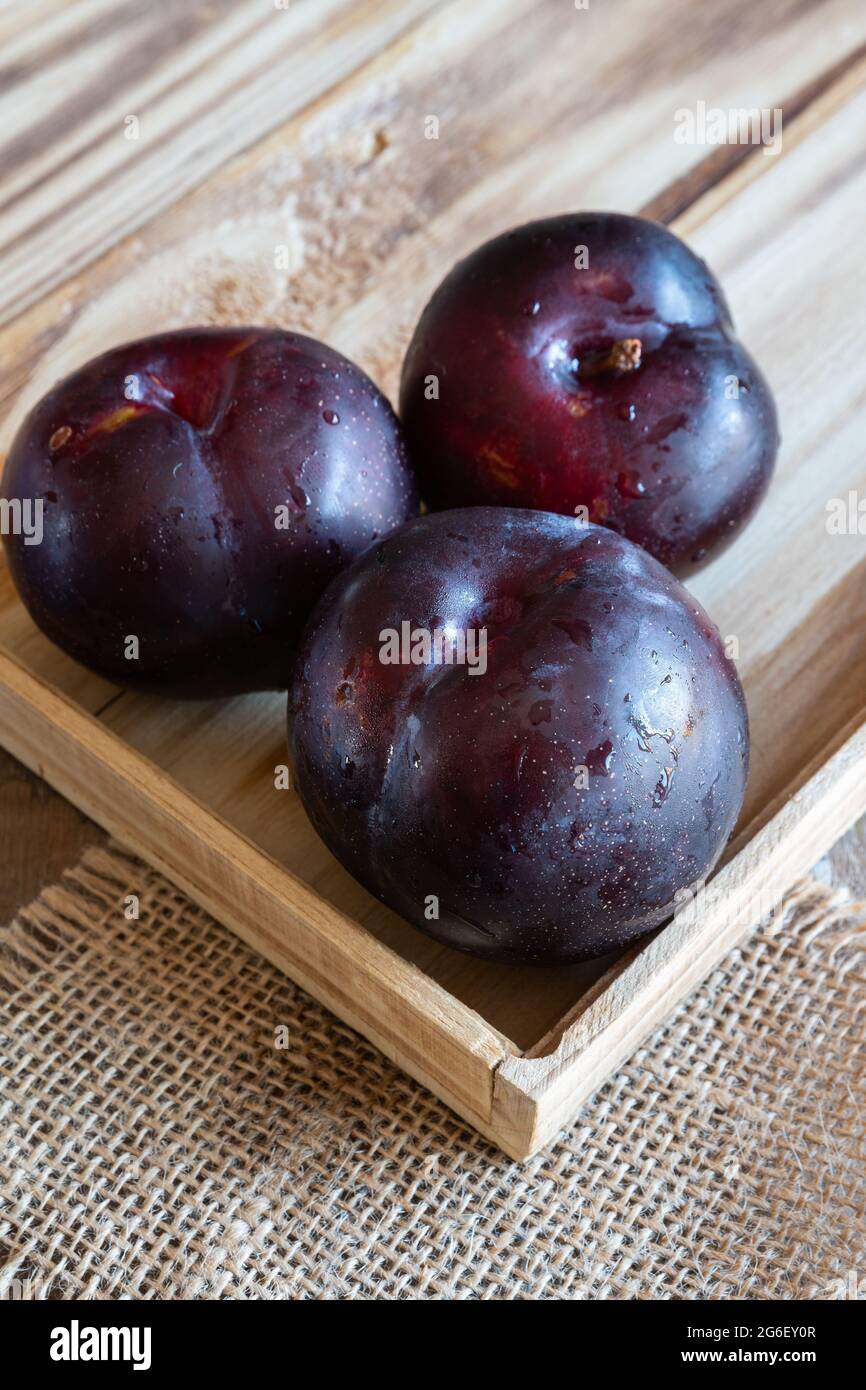 fresh fruit plums on rustic background Stock Photo - Alamy