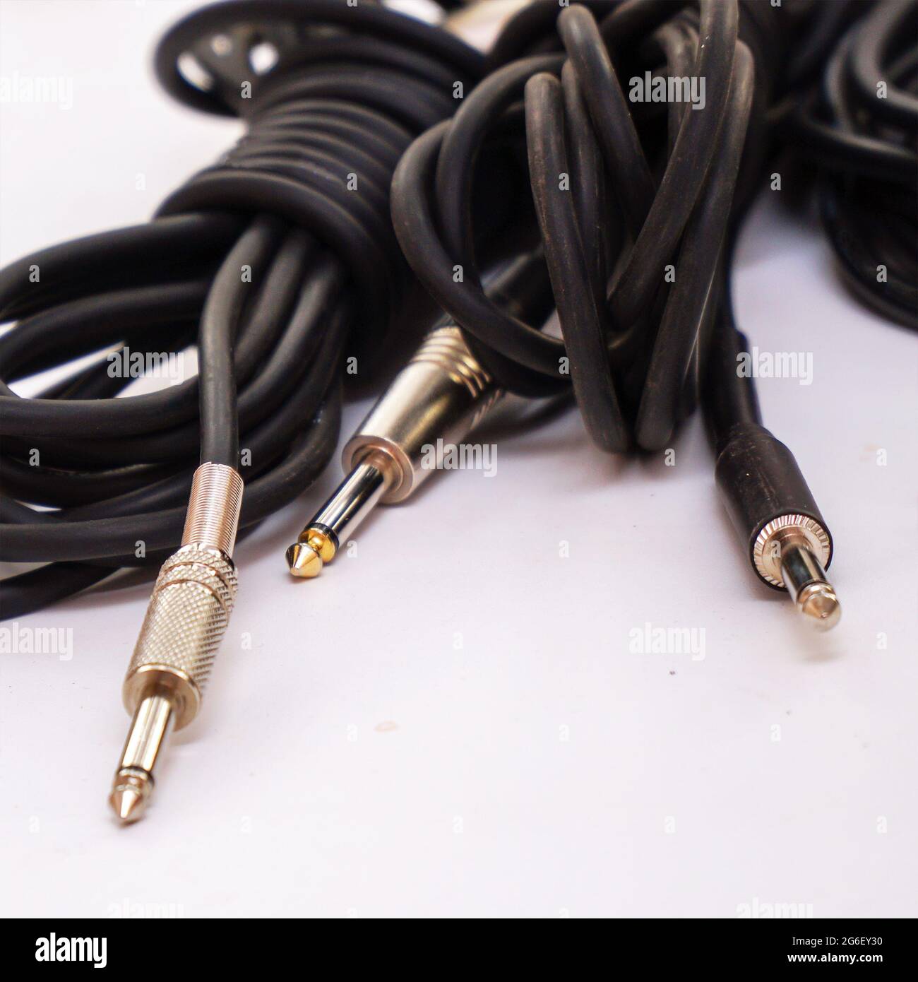 Audio cables for musical instruments and microphones on a white ...