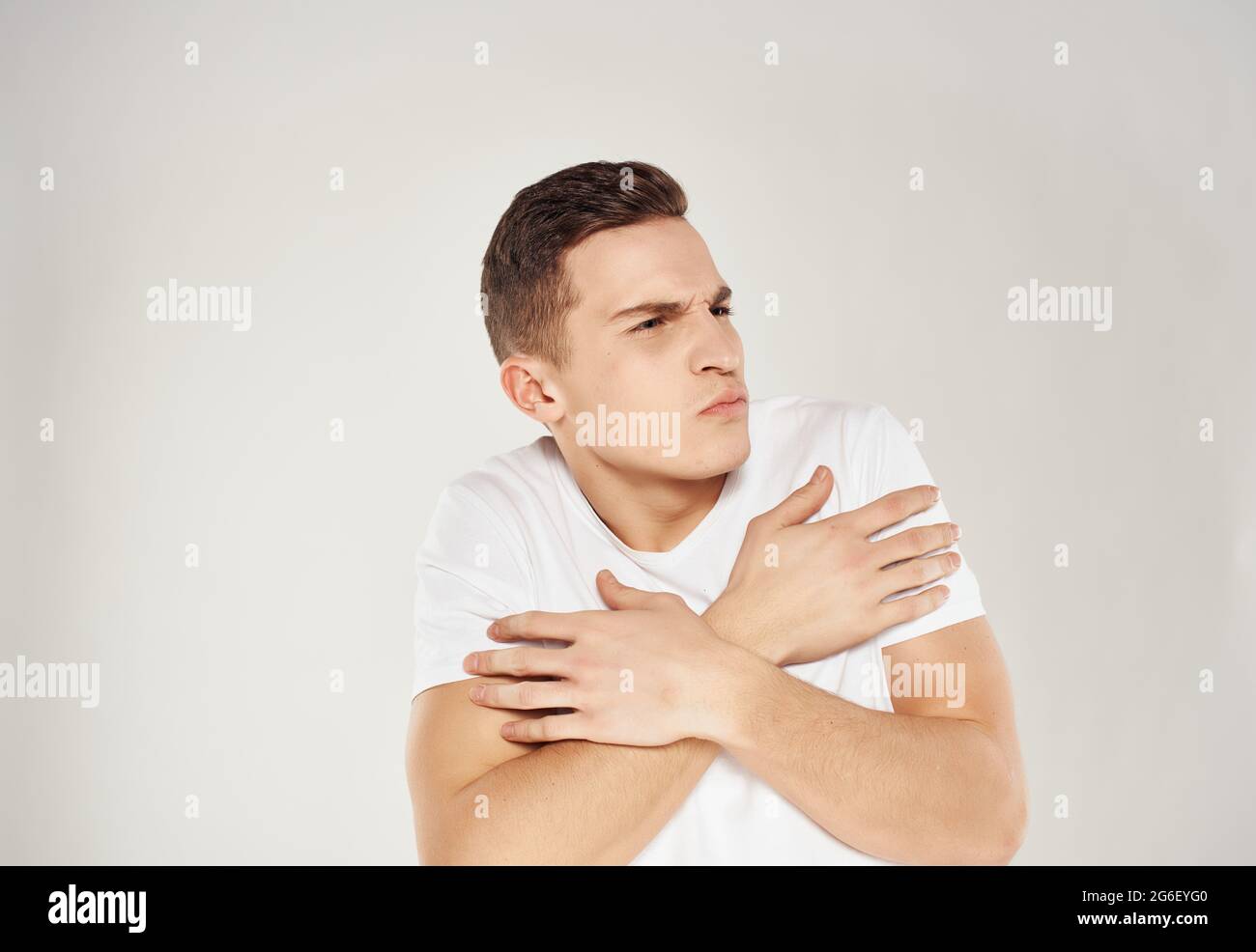 man with pensive facial expression in white t-shirt emotions isolated ...