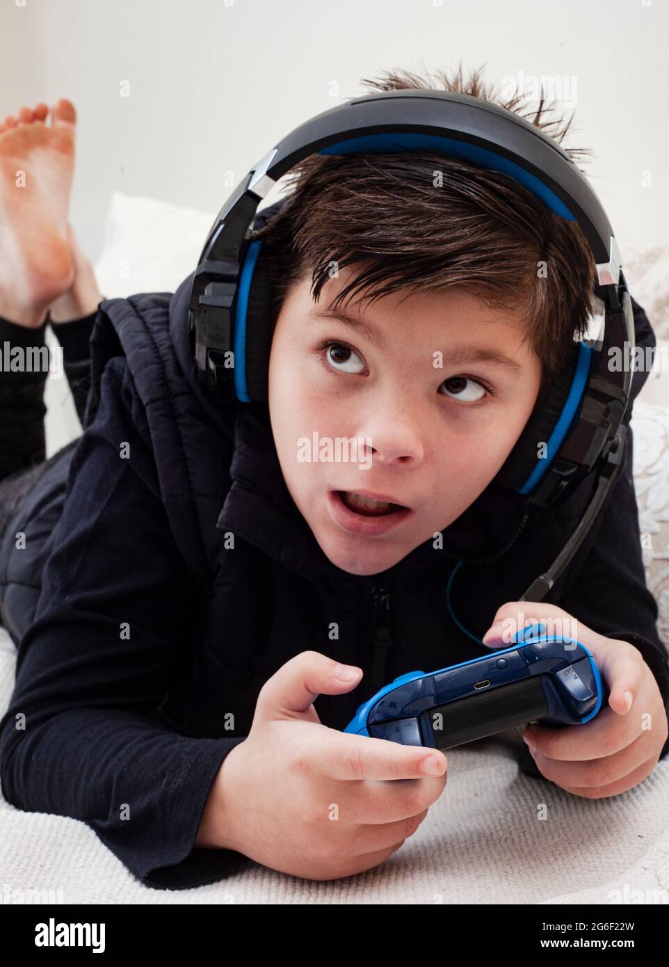 child wearing gaming headset and playing videogames Stock Photo - Alamy