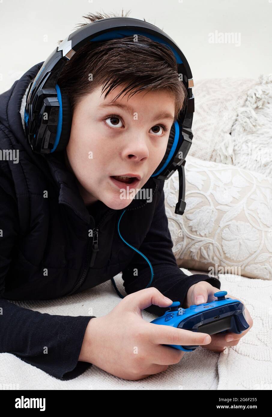 child playing video games and wearing gaming headset Stock Photo - Alamy