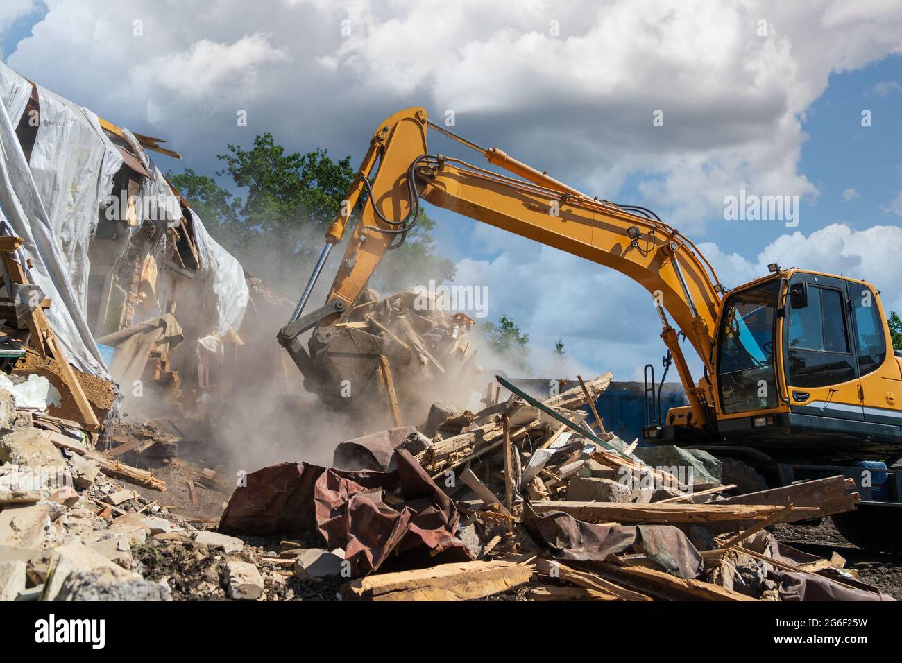 Process of demolition of old building dismantling. Excavator breaking ...