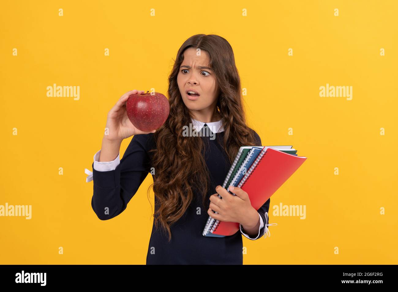 schoolgirl with apple lunch. back to school. teen girl eat apple after ...