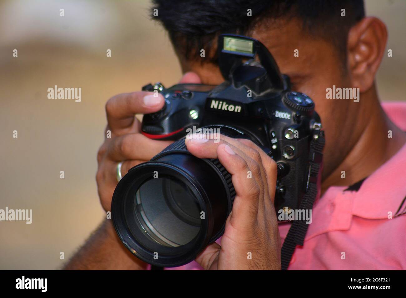 Indian Young Man using DSLR Camera Stock Photo - Alamy