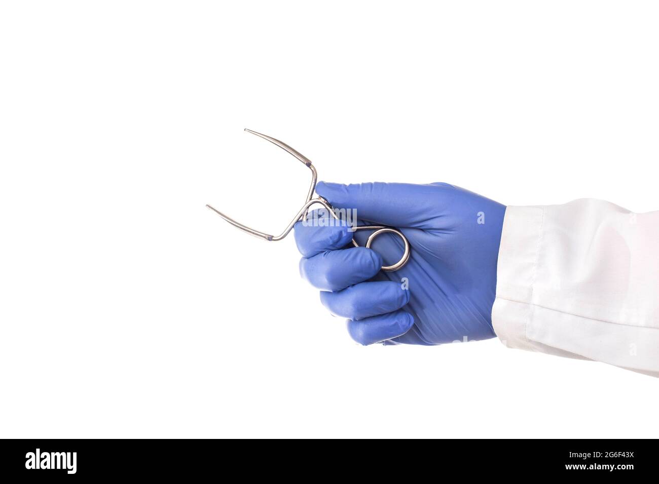 Doctor holds a medical instrument in his hand for performing surgical ...
