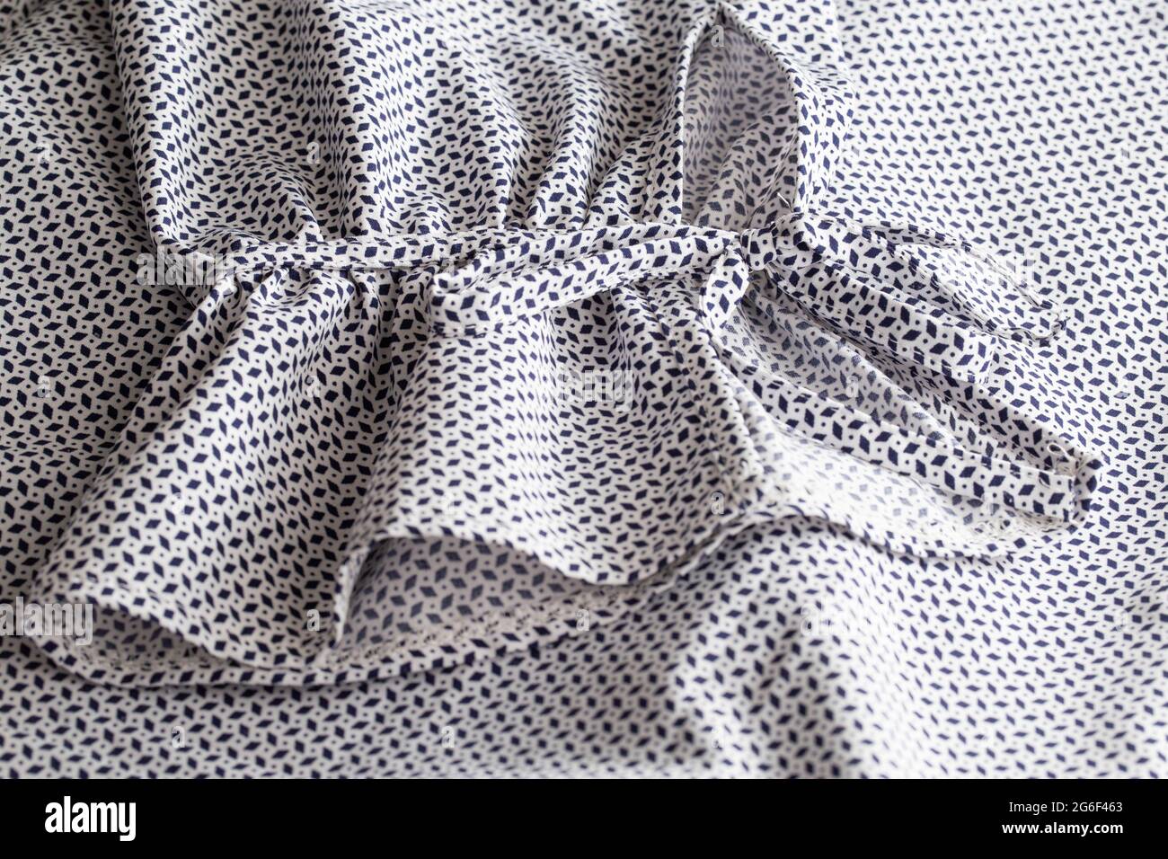 Variegated beautiful fabric from a blouse, lace tying a sleeve, close ...