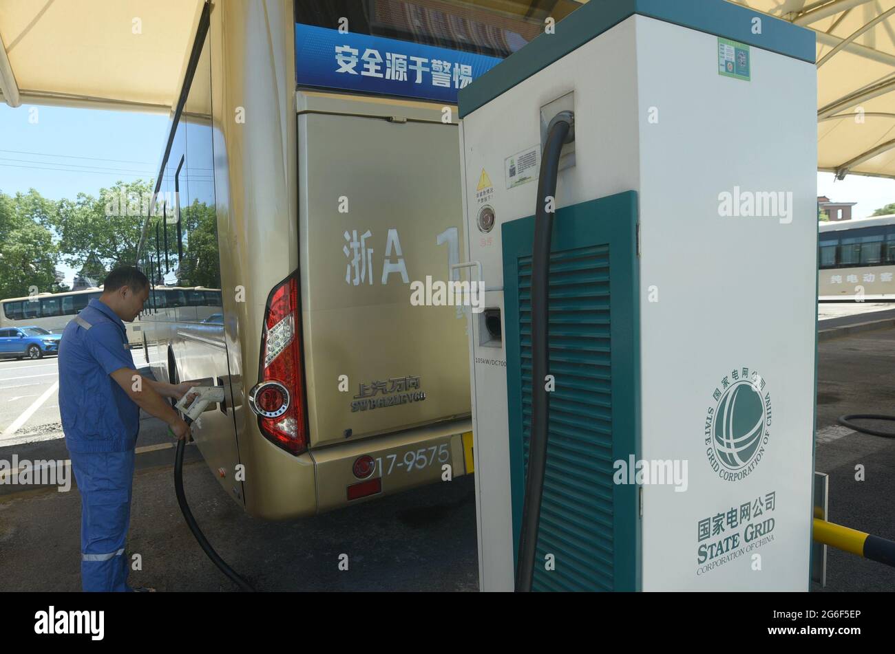 HANGZHOU, CHINA - JULY 6, 2021 - A bus company driver charges a bus ...
