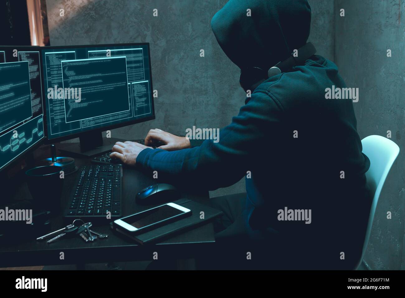 Hacker programmer using computer in dark room Stock Photo - Alamy
