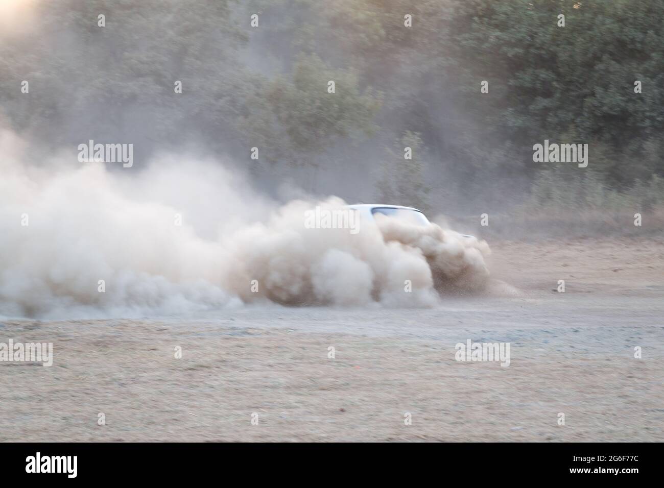 Drifting a car raises clouds of dust Stock Photo - Alamy