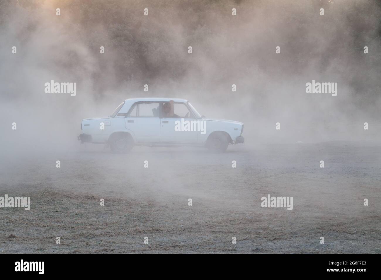 Drifting a car raises clouds of dust Stock Photo - Alamy