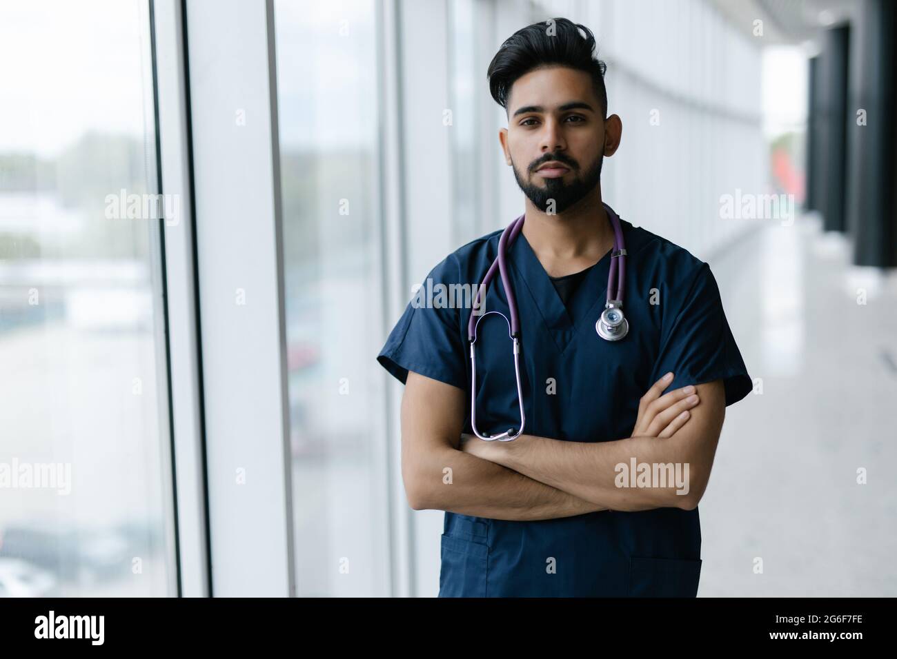 Young Indian doctor with a stethoscope on among a modern hospital ...