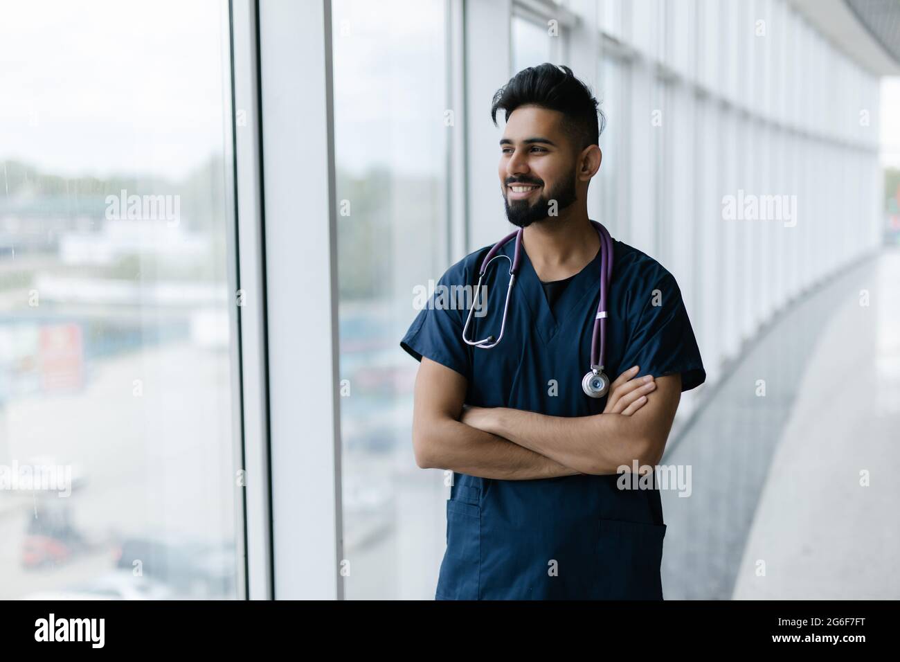 Young Indian doctor with a stethoscope on among a modern hospital ...