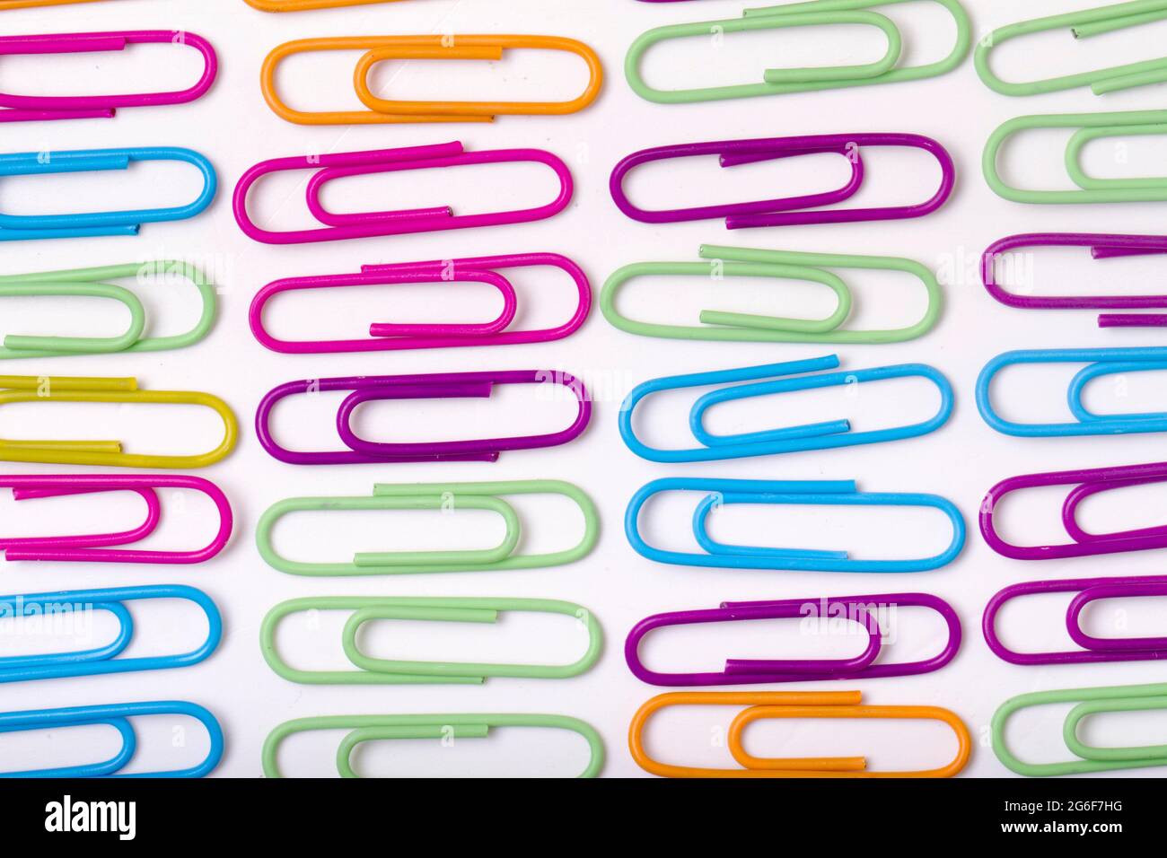 Close up view of vertical lines of colorful office paper clips isolated ...