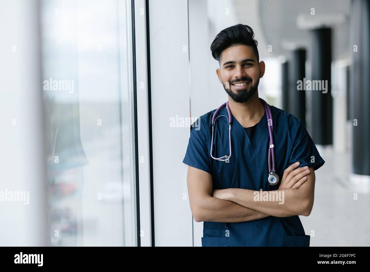 Young Indian doctor with a stethoscope on among a modern hospital ...