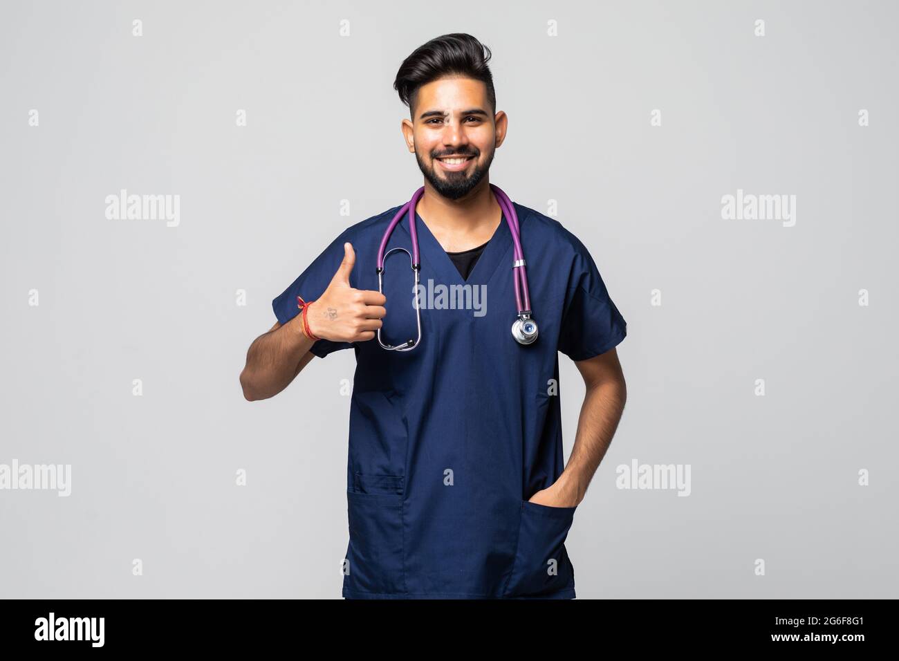 Happy smiling indian doctor with thumbs up gesture, isolated on white ...