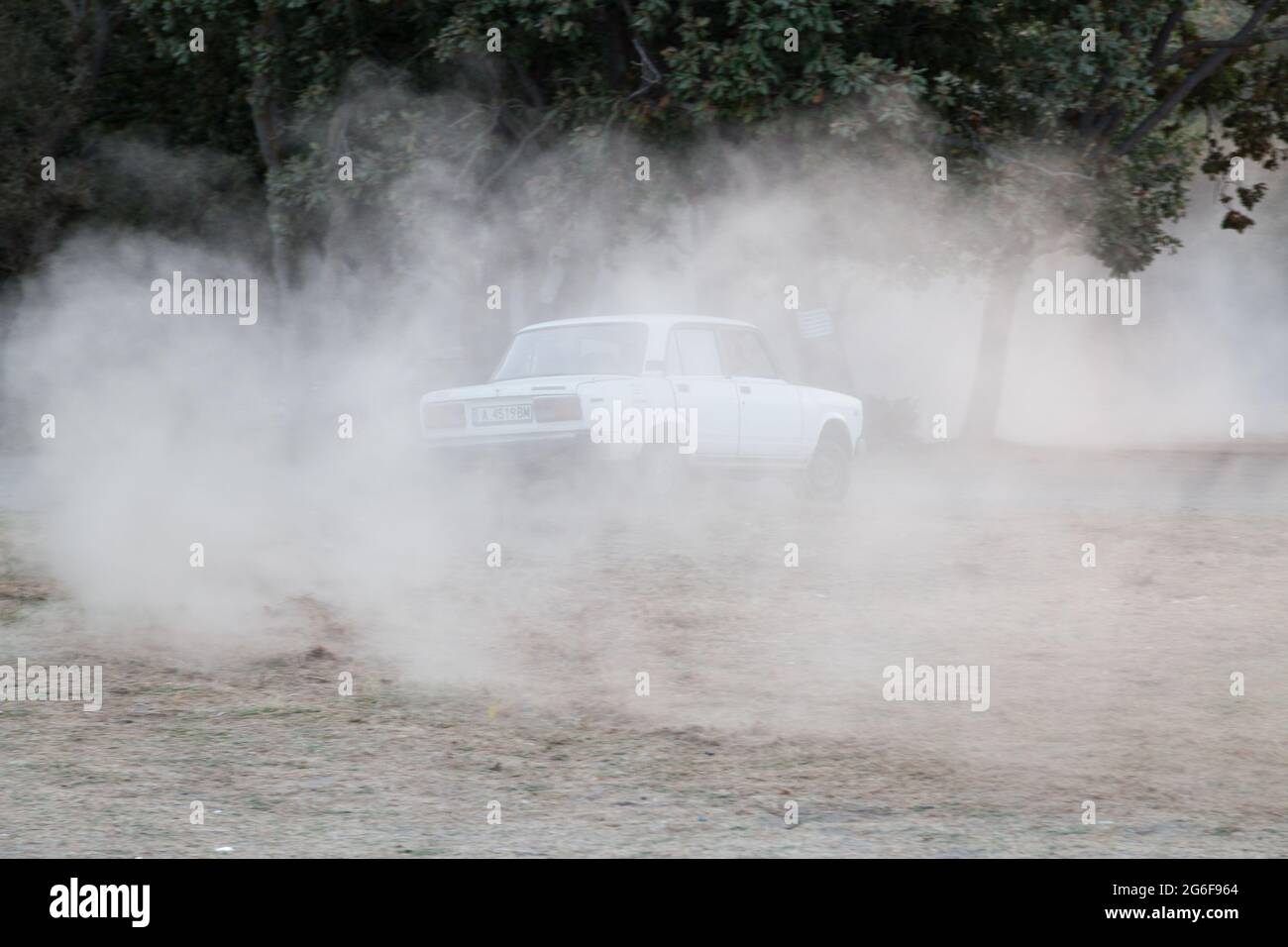 Drifting a car raises clouds of dust Stock Photo - Alamy