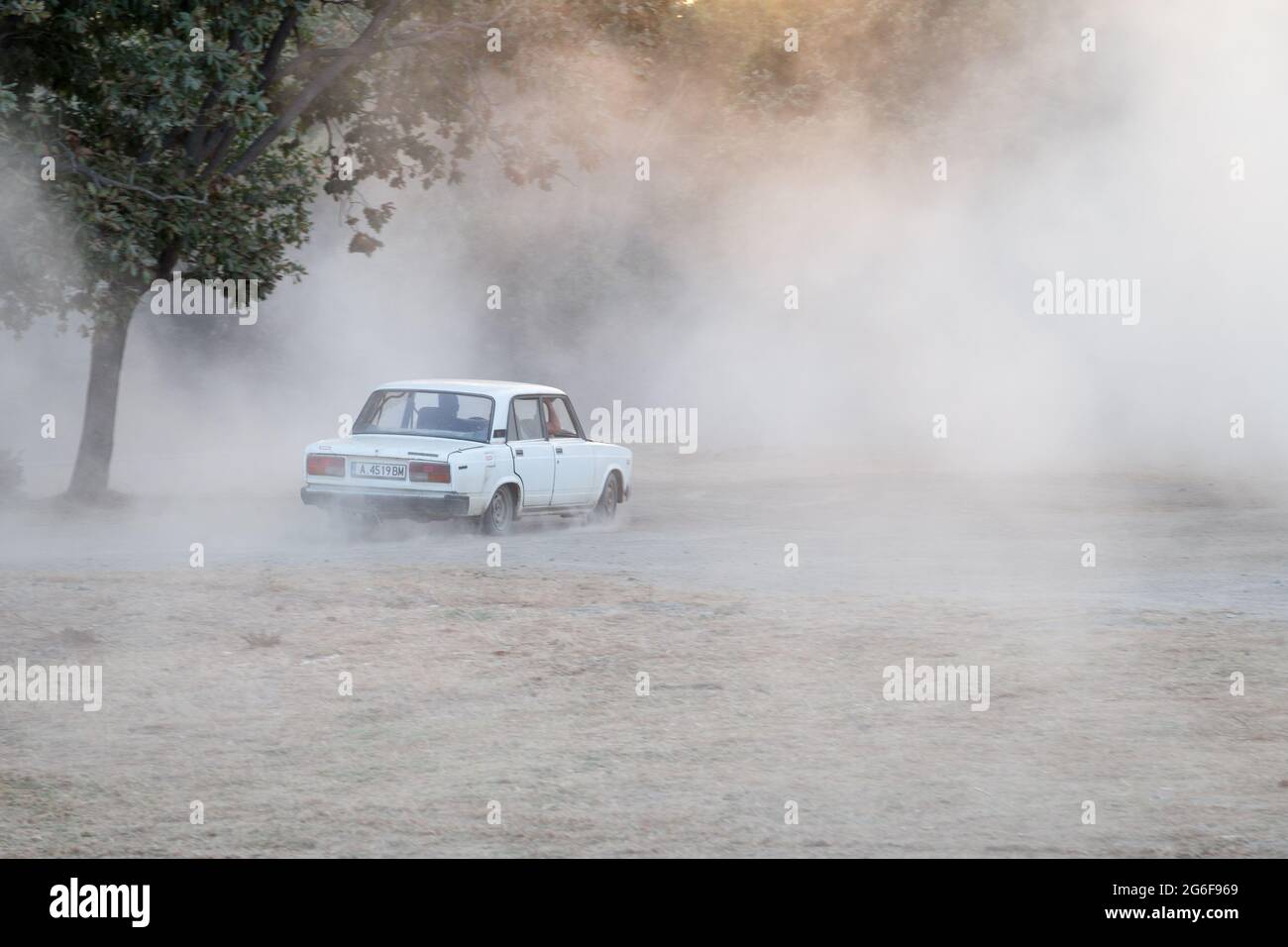 Drifting a car raises clouds of dust Stock Photo - Alamy
