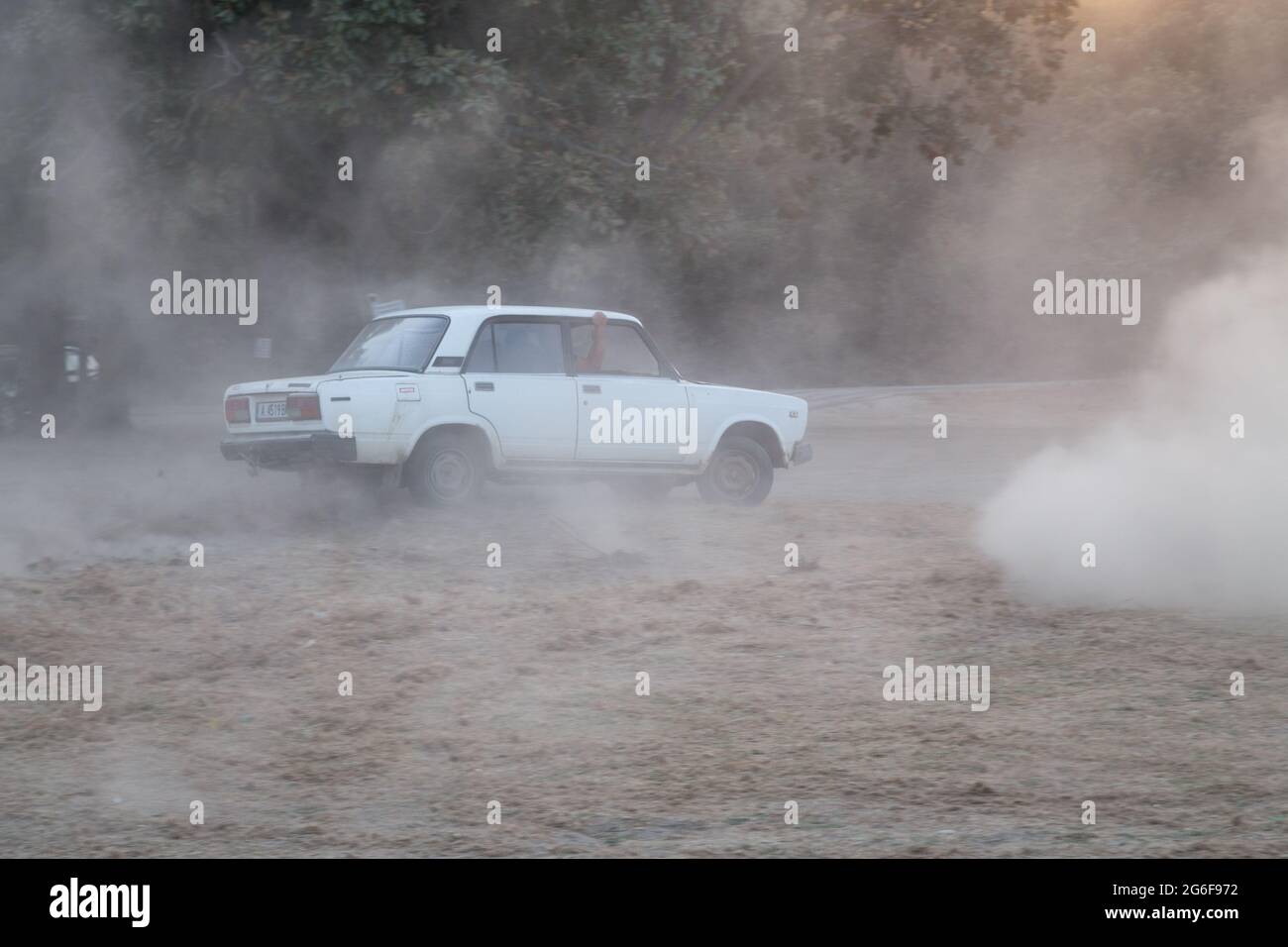 Drifting a car raises clouds of dust Stock Photo - Alamy