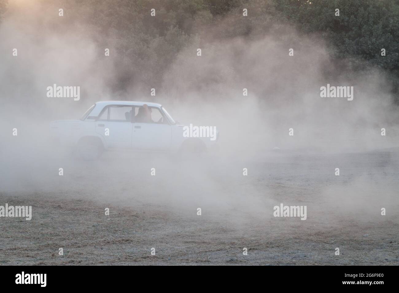 Drifting a car raises clouds of dust Stock Photo - Alamy
