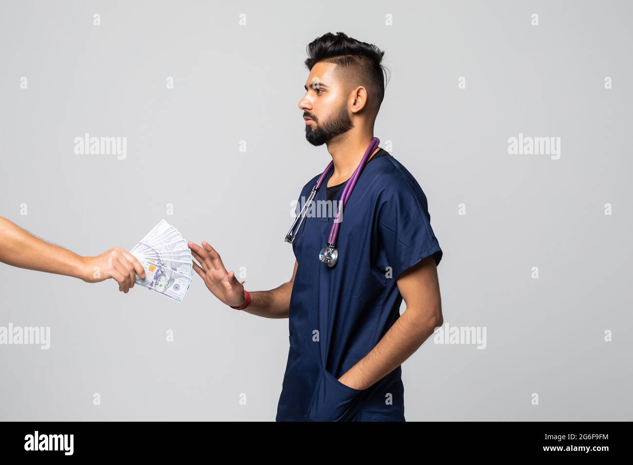 Man giving bribe to a indian doctor refusing the money, isolated on ...