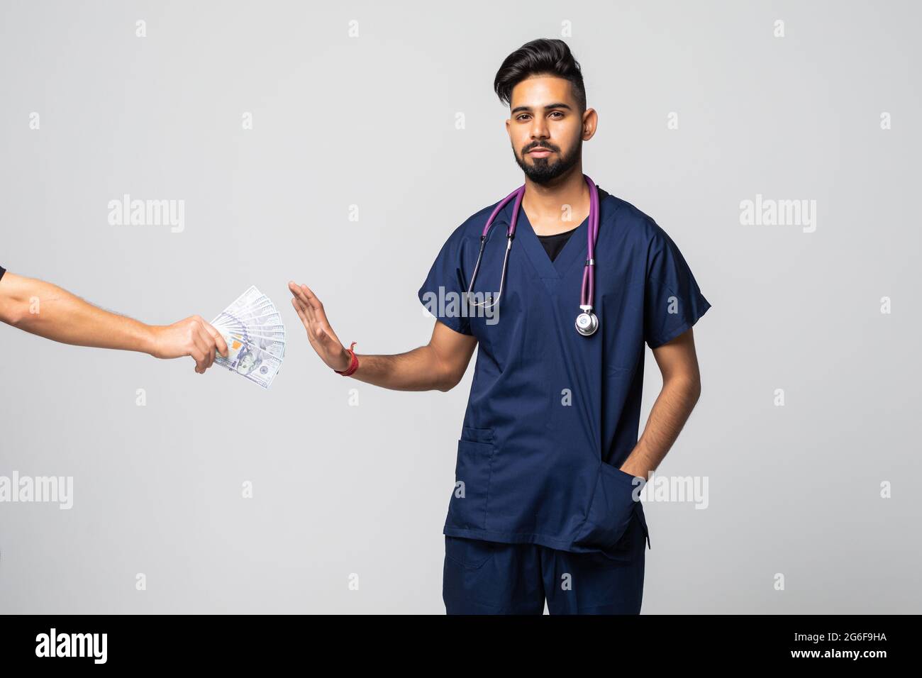 Man giving bribe to a indian doctor refusing the money, isolated on ...