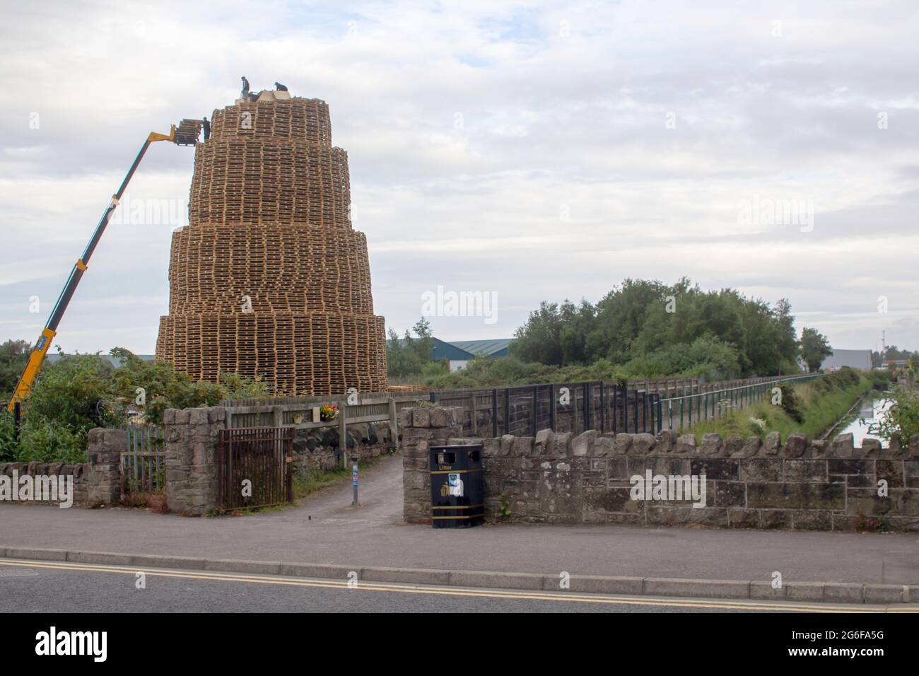 4 July 2021 Youths on top of the very tall bonfire made from thousands ...