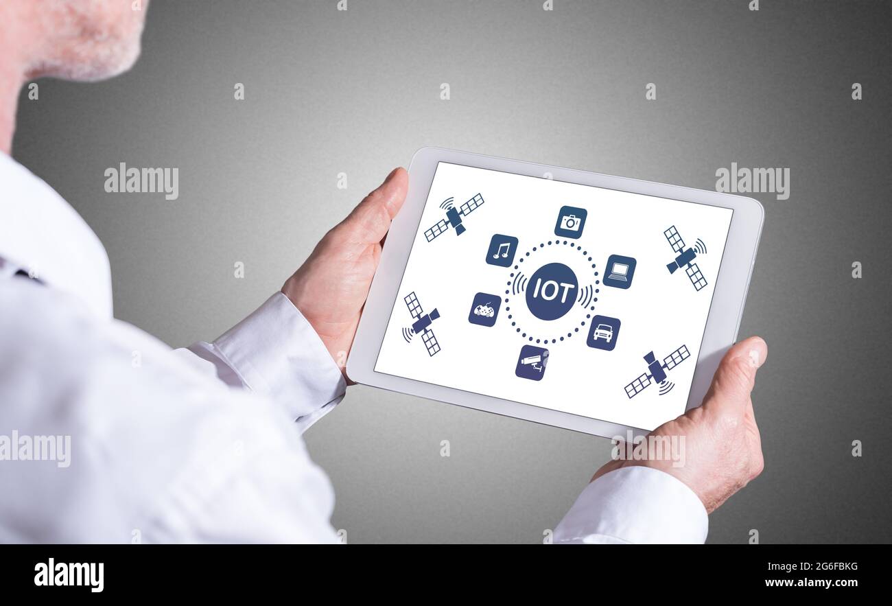Man holding a tablet showing iot concept Stock Photo - Alamy