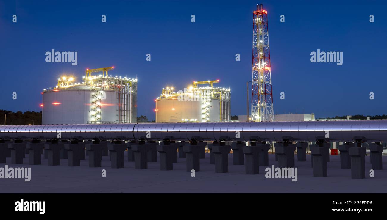 Pipelines, gas tanks in the LNG terminal at night Stock Photo - Alamy