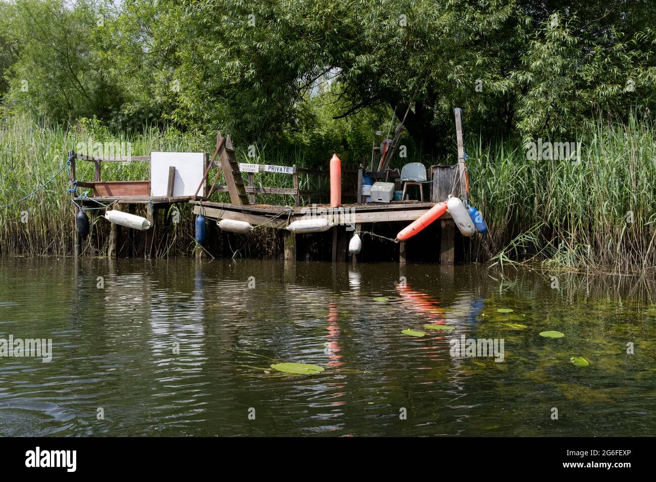 A riverside landscape of decaying wood, a private mooring structure in ...