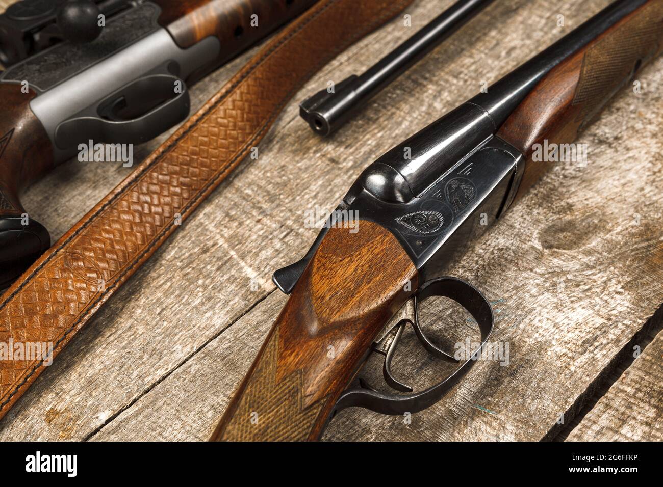 Many hunting rifles on weathered wooden surface Stock Photo - Alamy