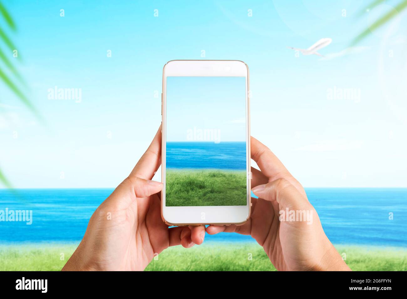 Human hand with the mobile phone taking a picture on the field with ...