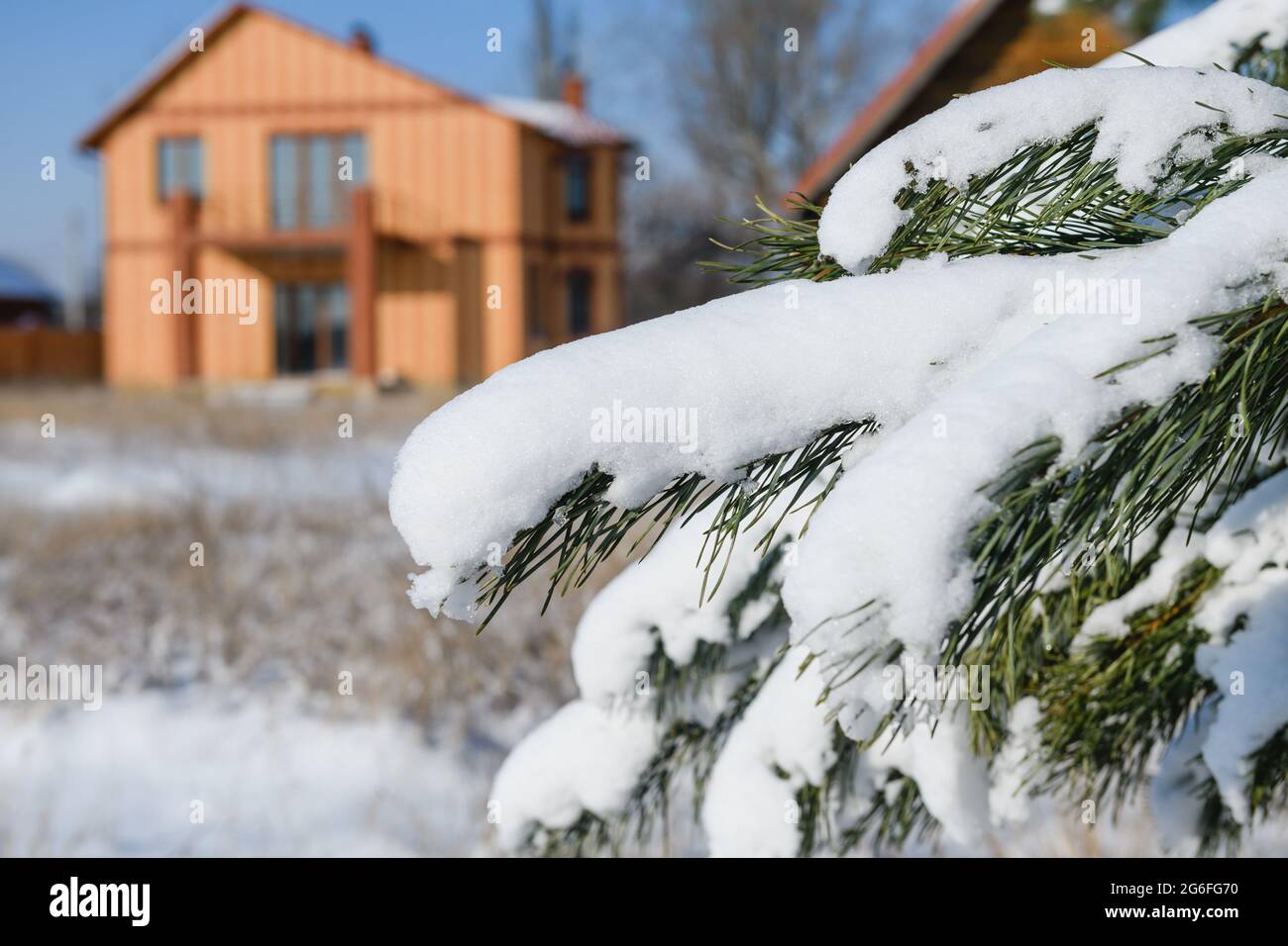 Winter rural scene with fir tree branches in heavy snow and wooden ...