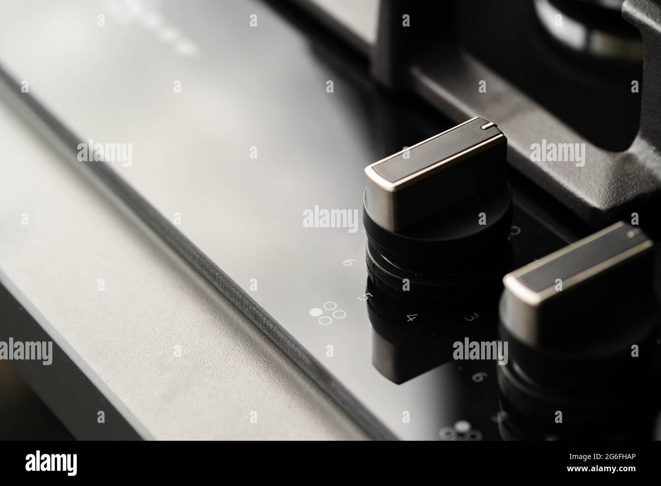 Switch knob of a modern kitchen stove Stock Photo - Alamy