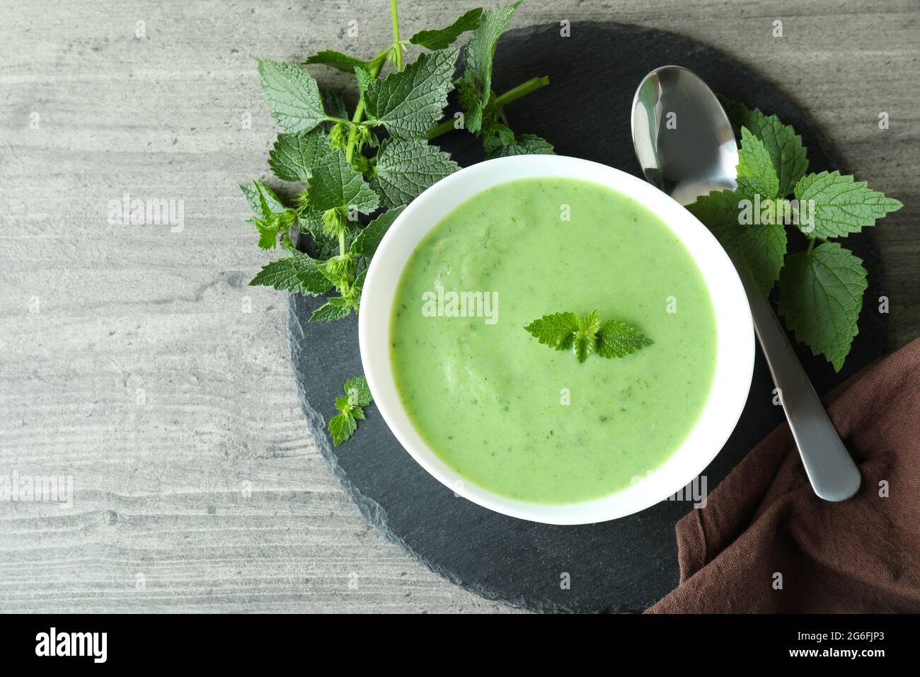 Concept of healthy food with nettle soup on gray textured table Stock ...