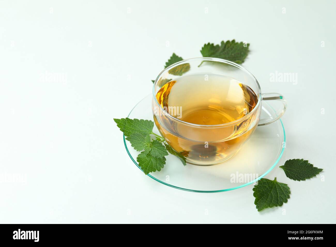 Cup of nettle tea and ingredients on white background Stock Photo - Alamy
