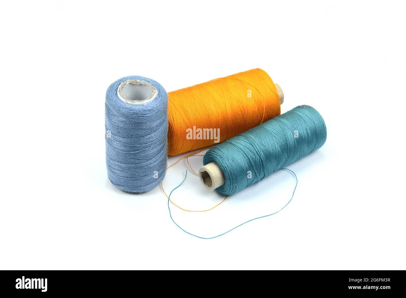 Color sewing threads isolated on white background Stock Photo - Alamy