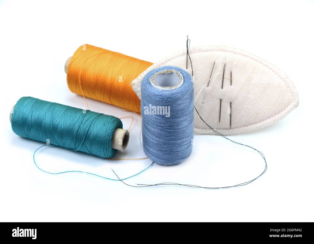 Color sewing threads isolated on white background Stock Photo - Alamy