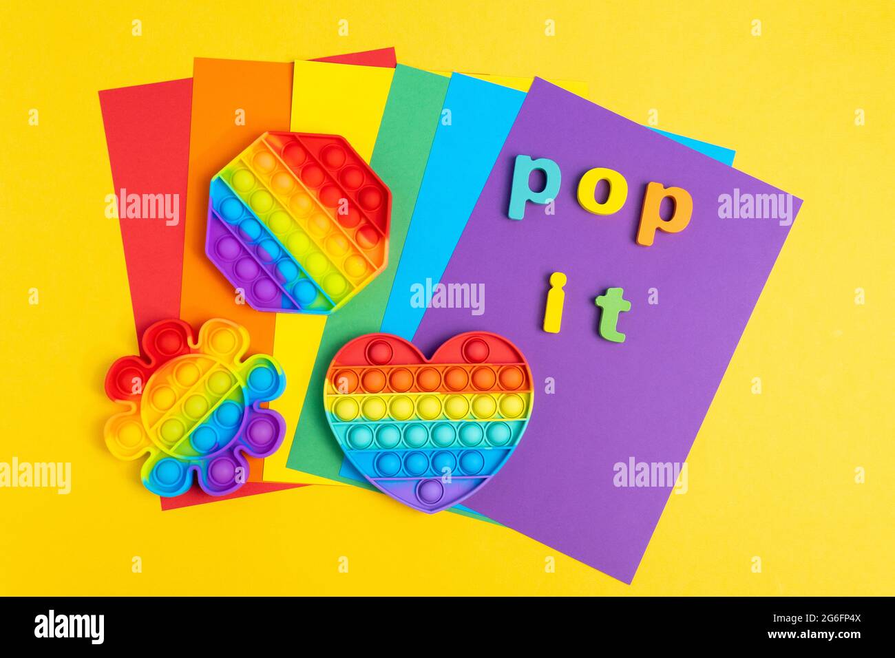 Pop it fidget sensory toy on a yellow background. Top view Stock Photo ...