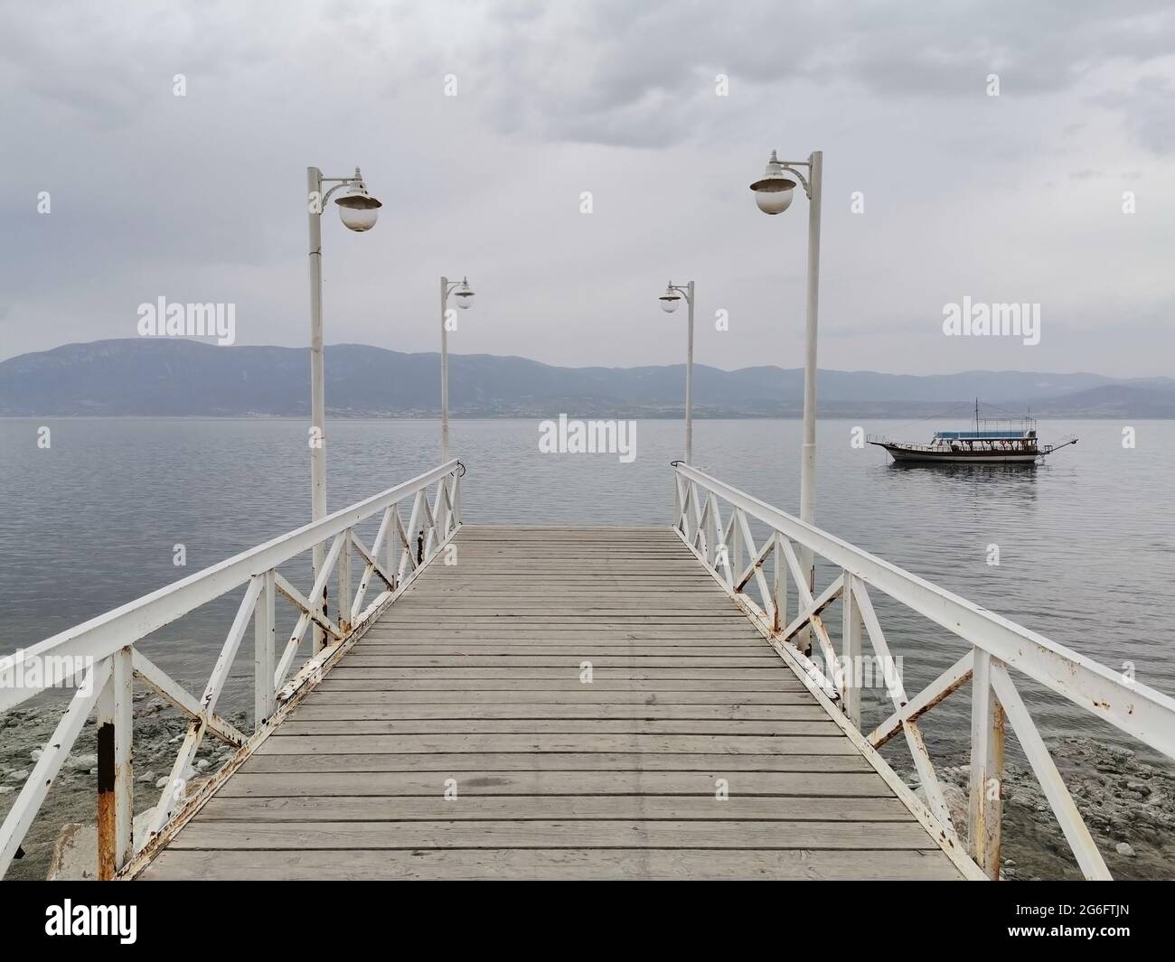 Walking path towards the lake. Lake, boat, sky and clouds Stock Photo ...