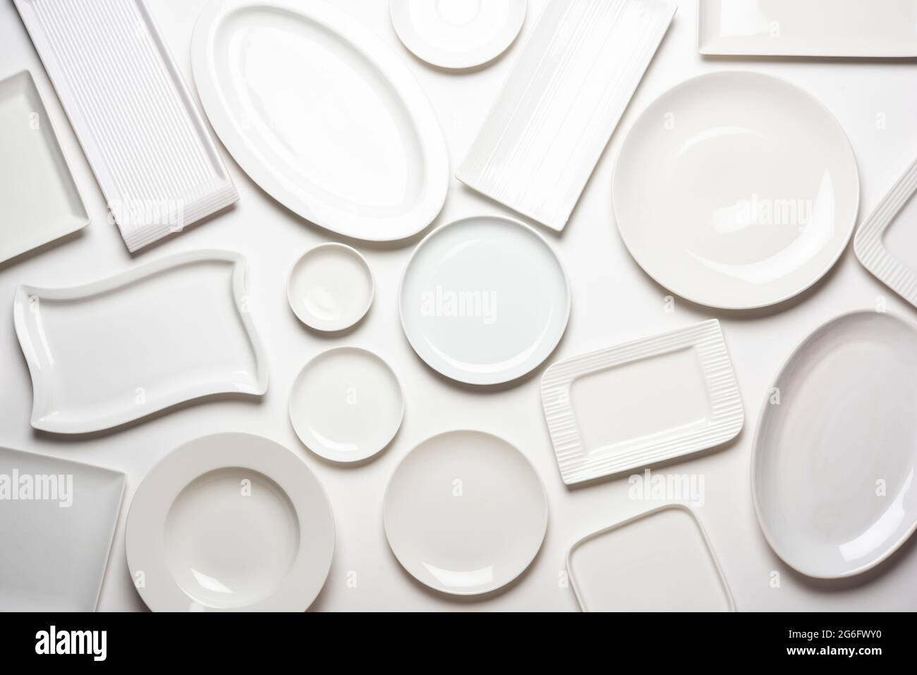 different shape white plates isolated on white background, top view ...