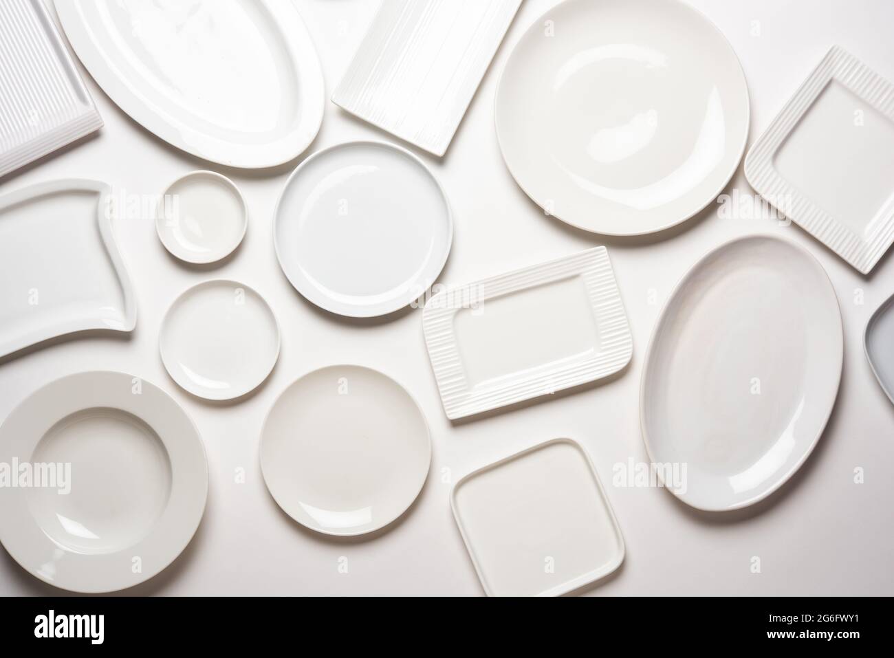 different shape white plates isolated on white background, top view ...