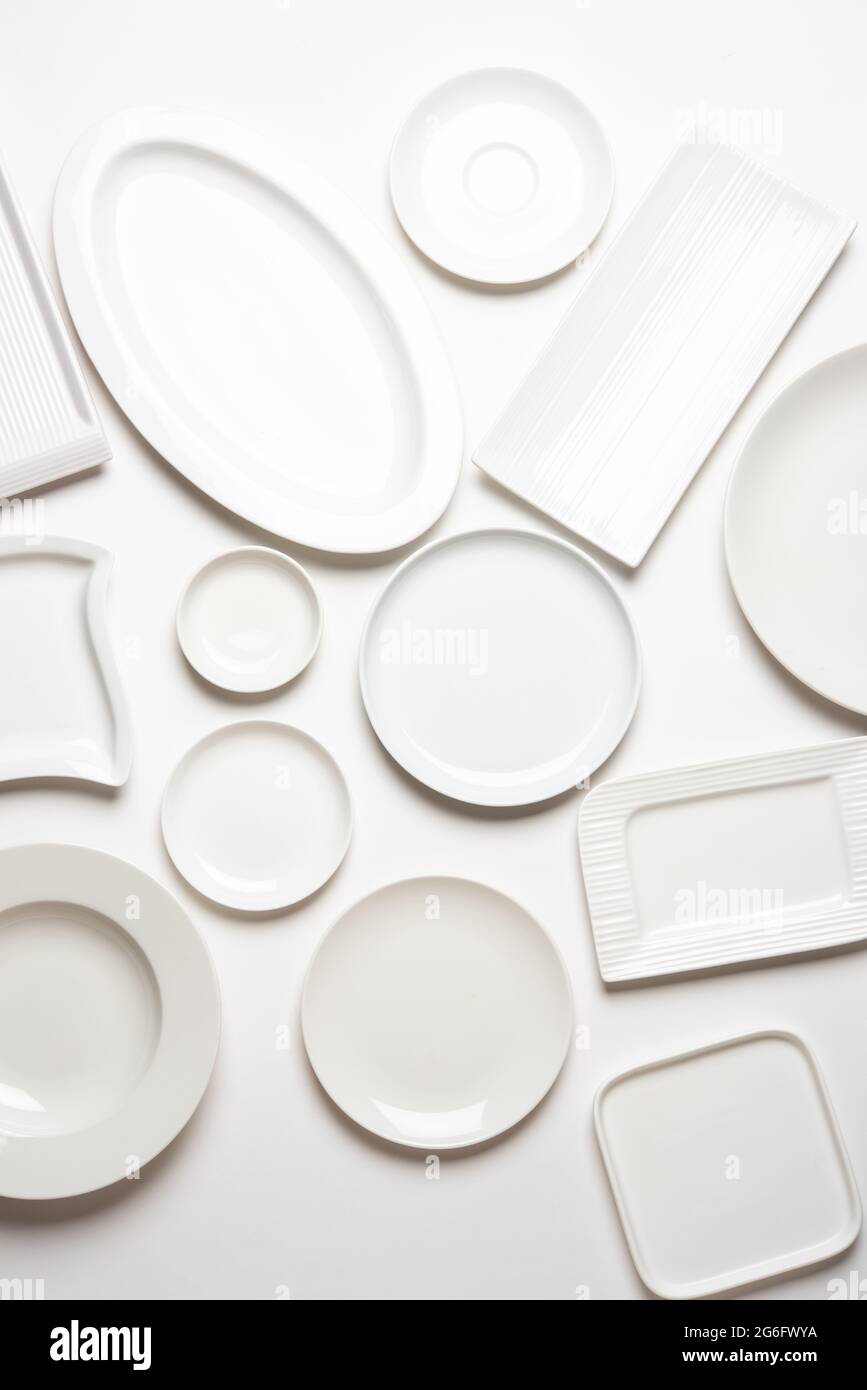 different shape white plates isolated on white background, top view ...