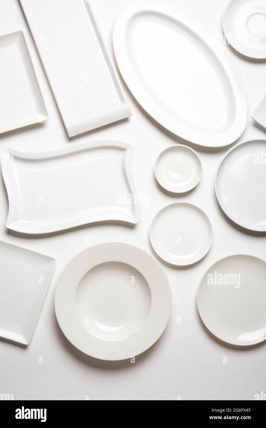 different shape white plates isolated on white background, top view ...