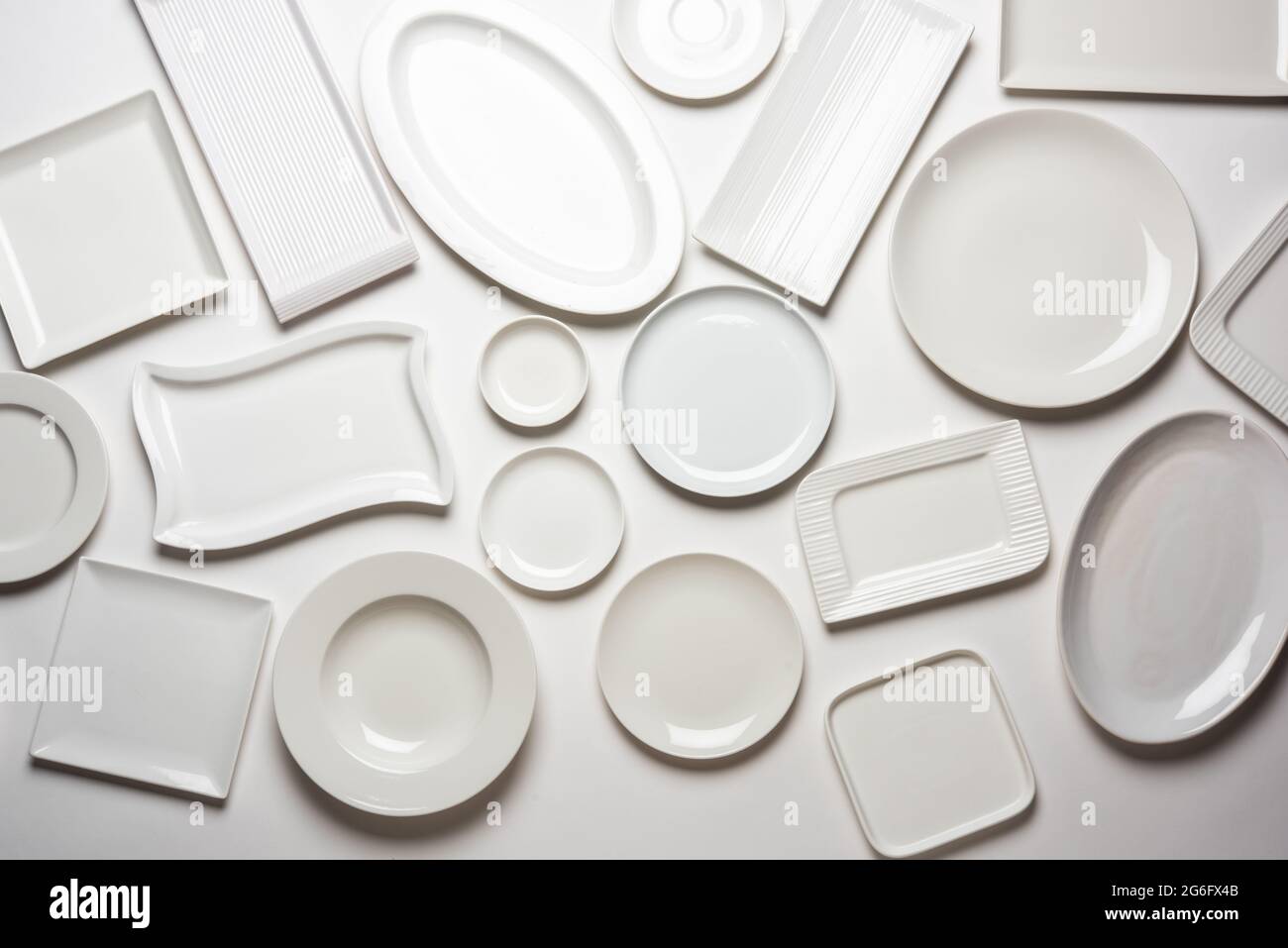 different shape white plates isolated on white background, top view ...