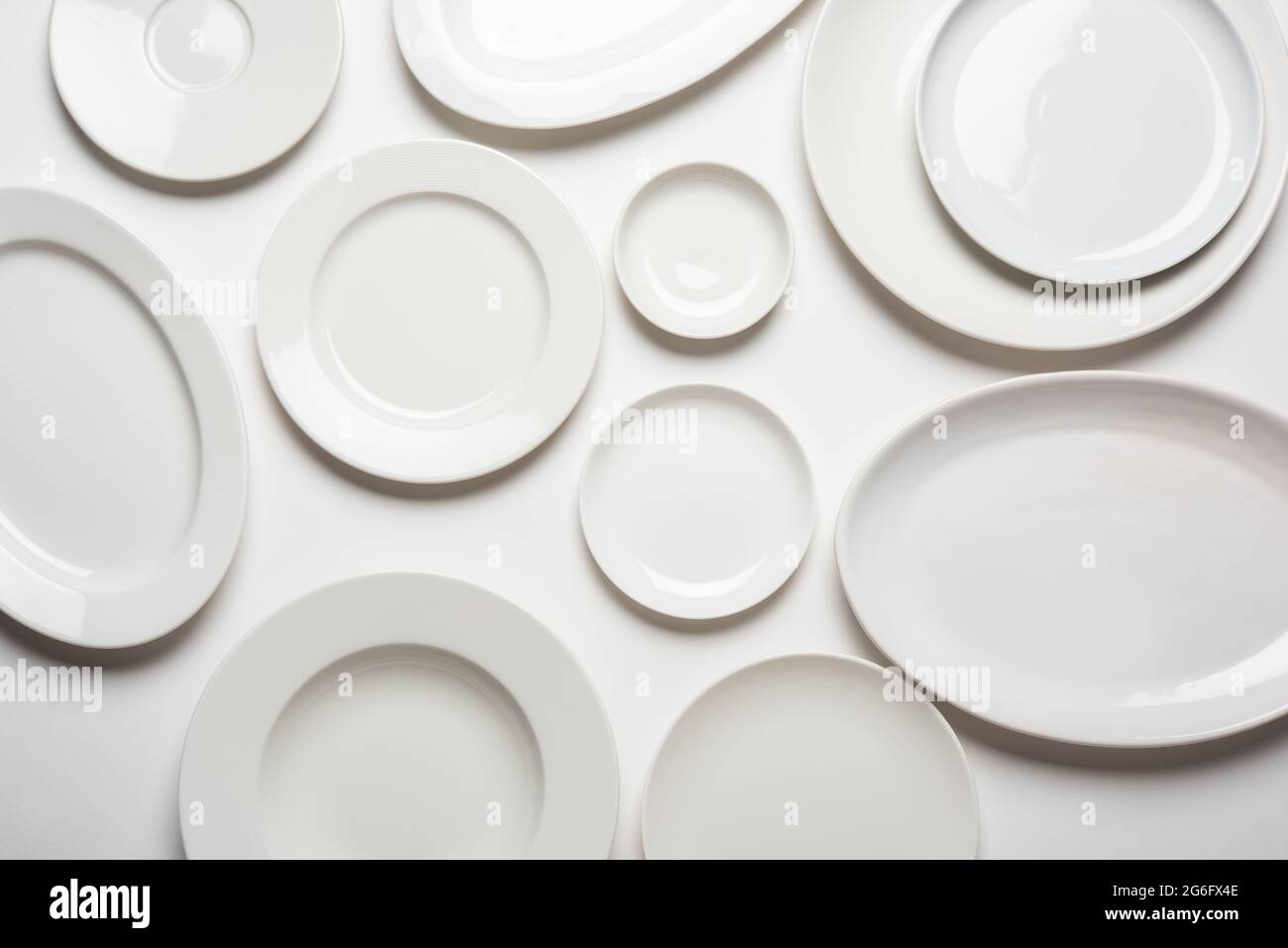 different shape white plates isolated on white background, top view ...