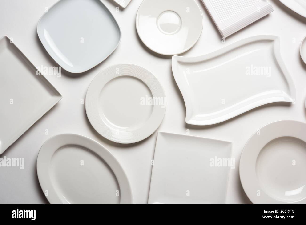 different shape white plates isolated on white background, top view ...