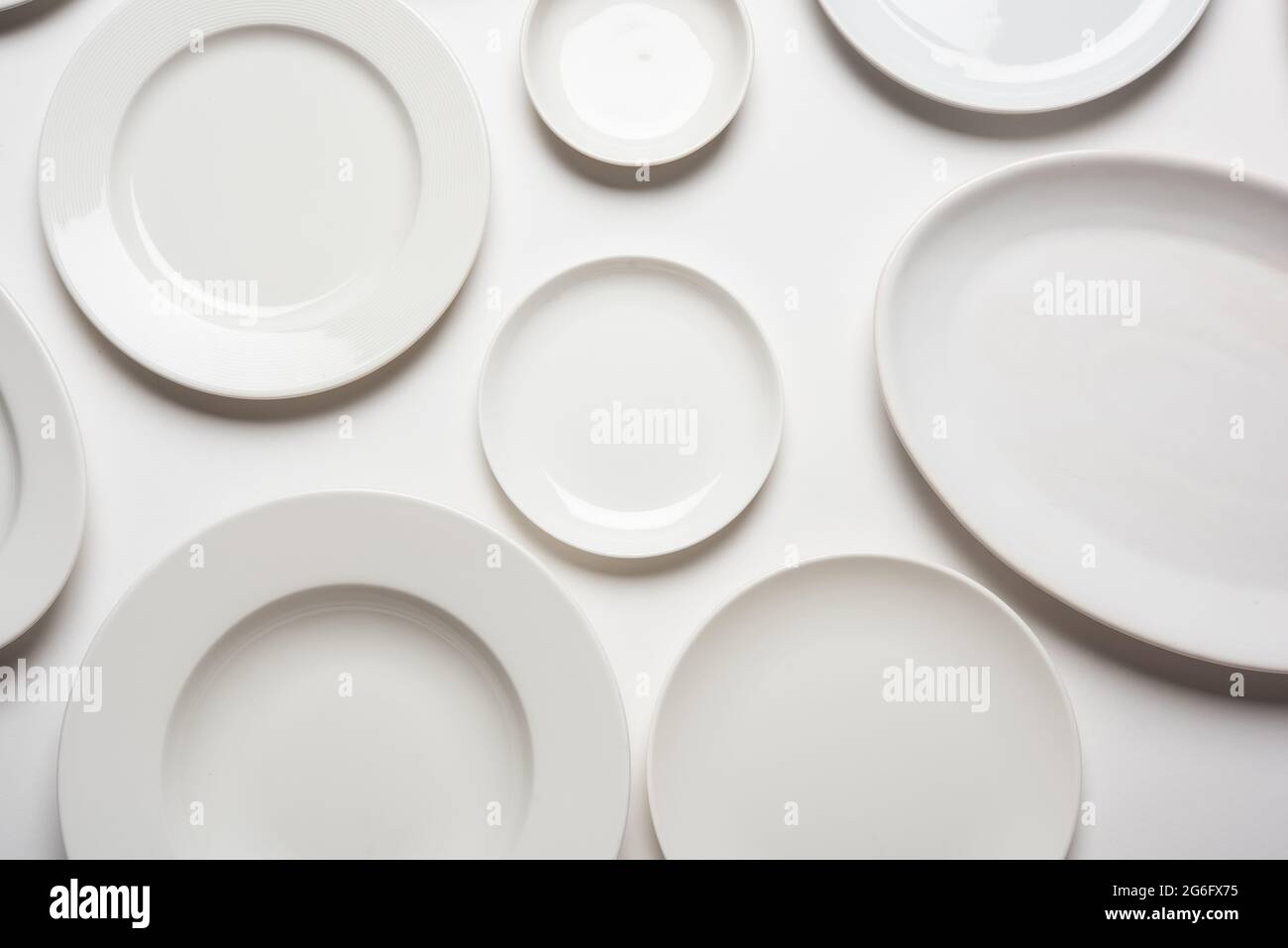 different shape white plates isolated on white background, top view ...