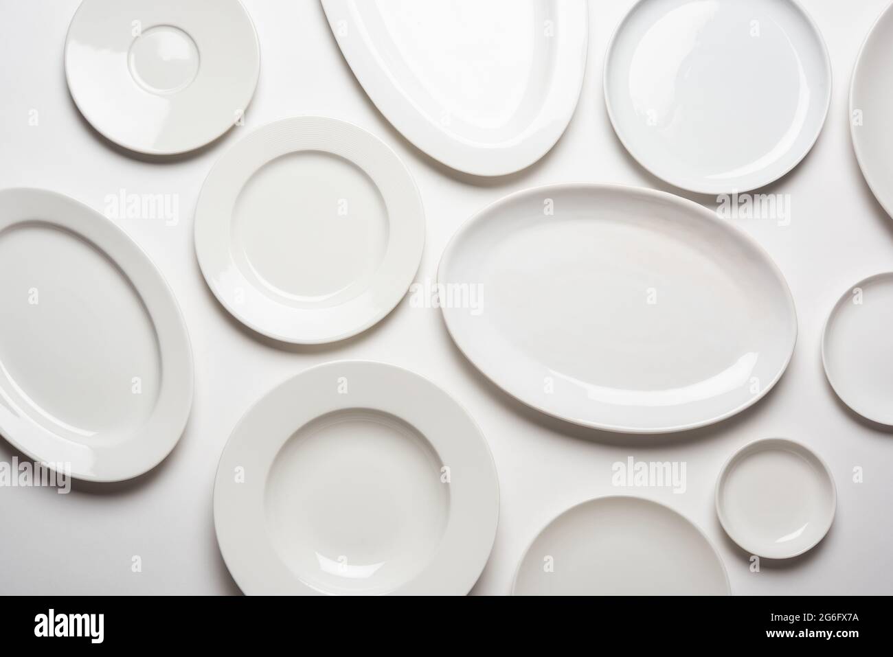 different shape white plates isolated on white background, top view ...